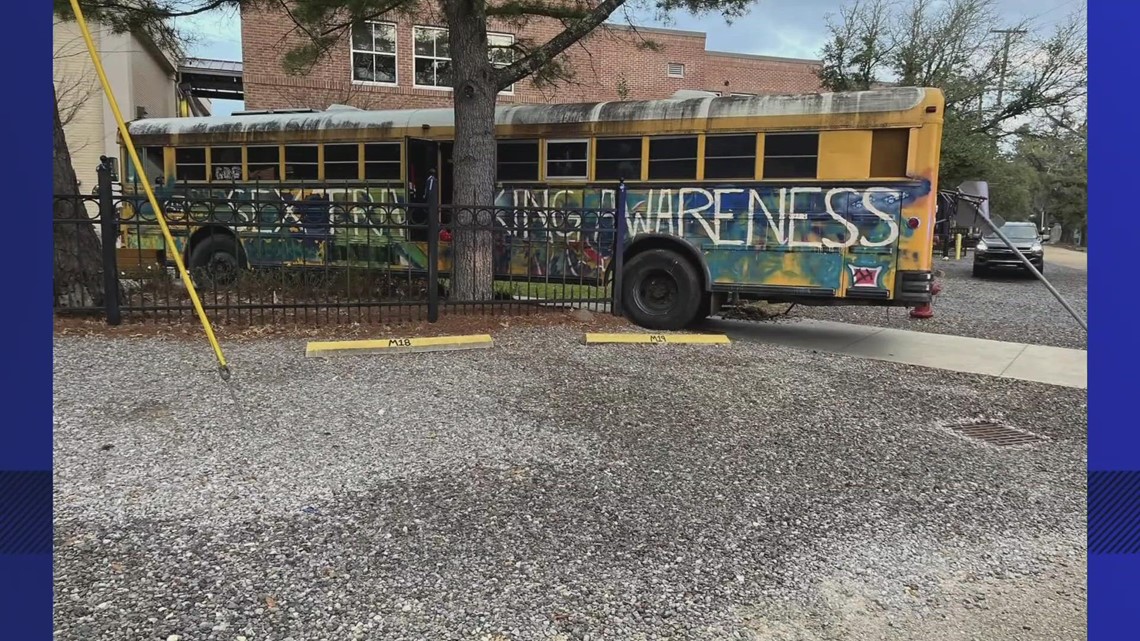 Woman driving school bus full of graffiti crashes into school in ...
