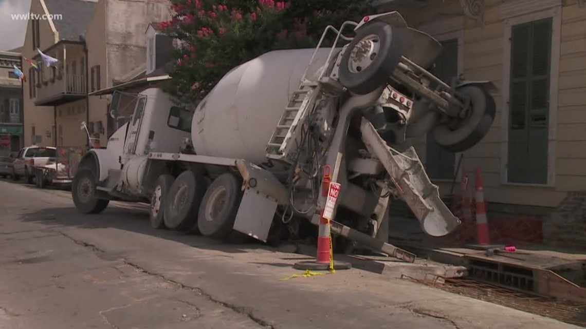 Cement truck falls into pothole while trying to fill other hole | wwltv.com