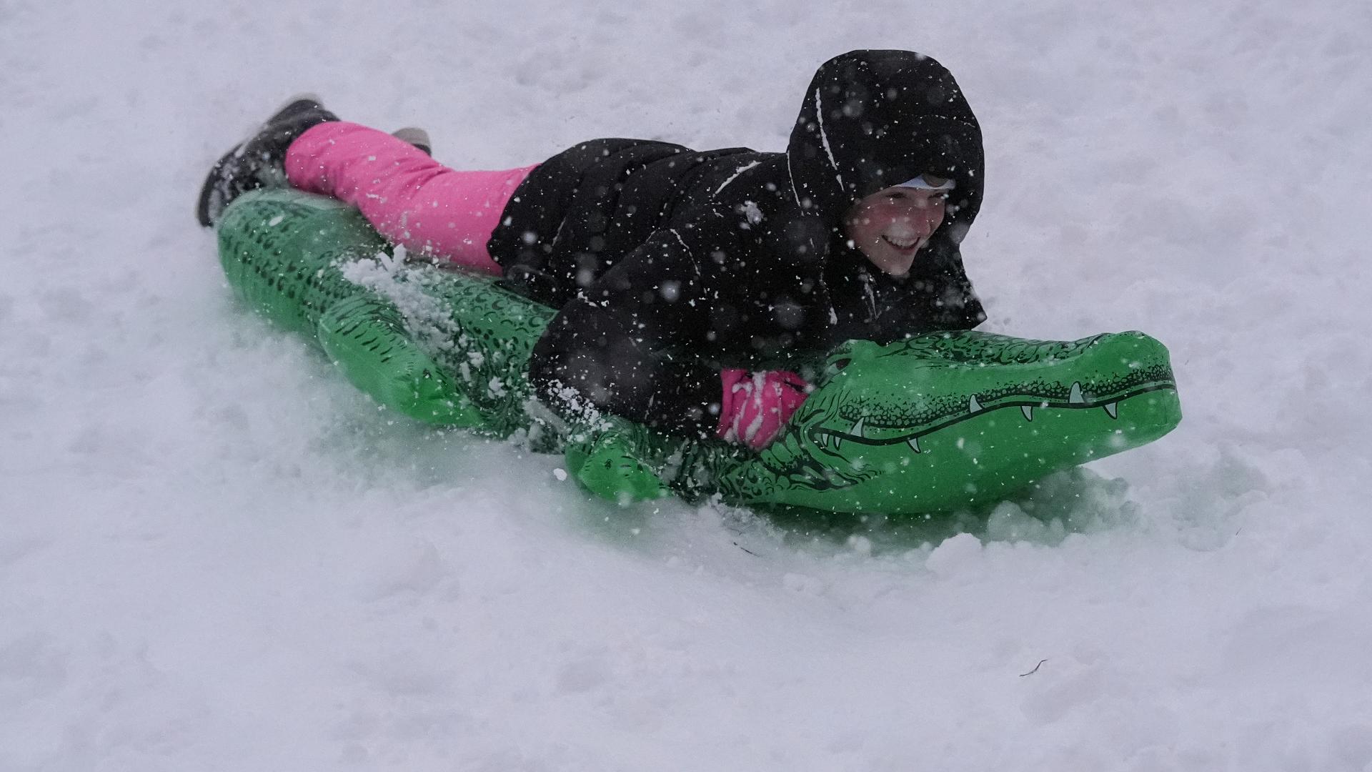 Residents ski on Bourbon Street, sled down the levee during historic ...